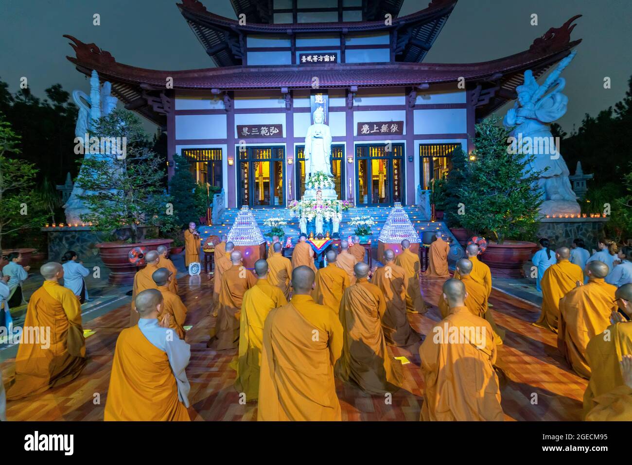 Kneeling monks in temple praying hi-res stock photography and images ...