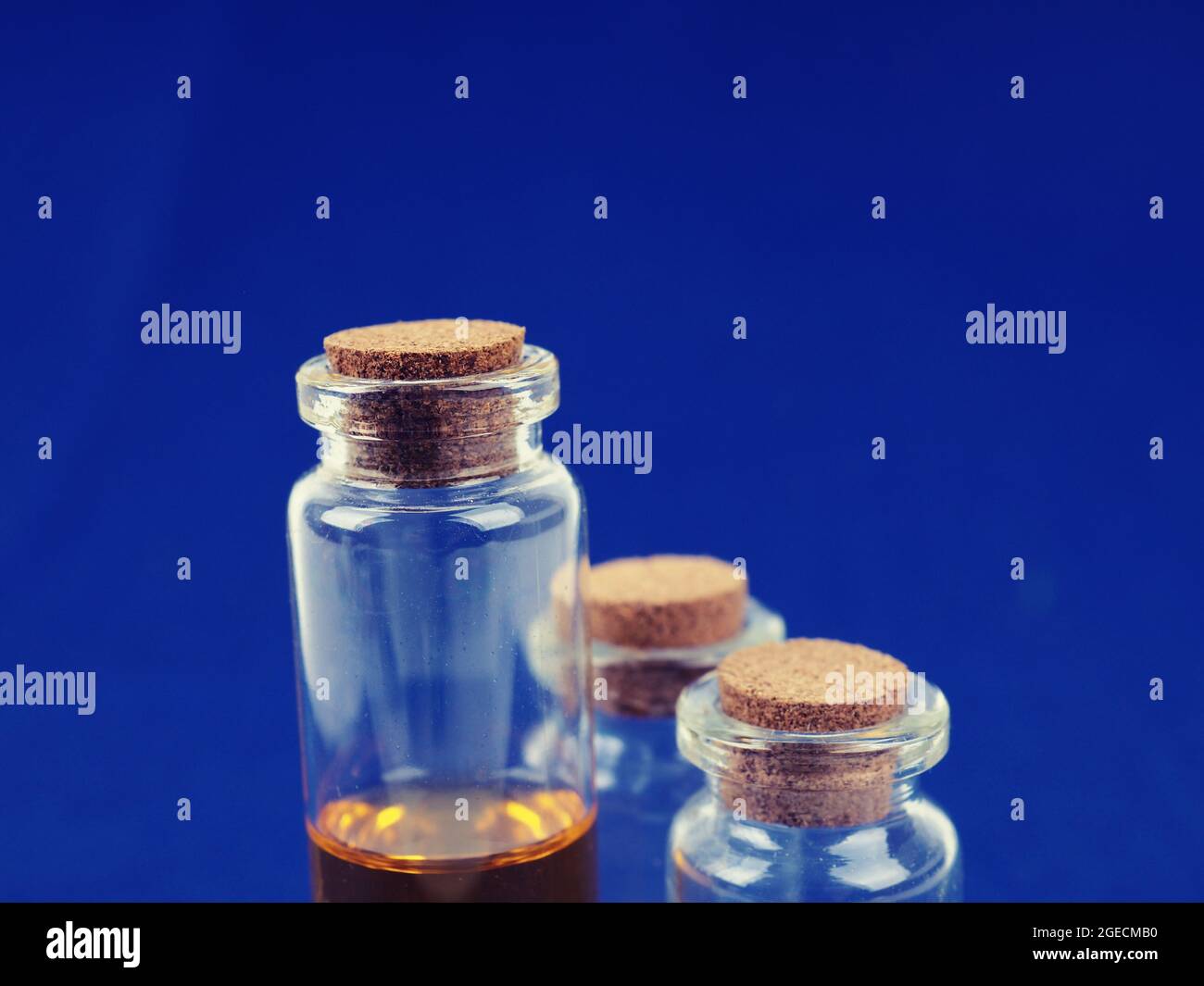 Several medical bottles, test tubes with a cork on a blue background ...