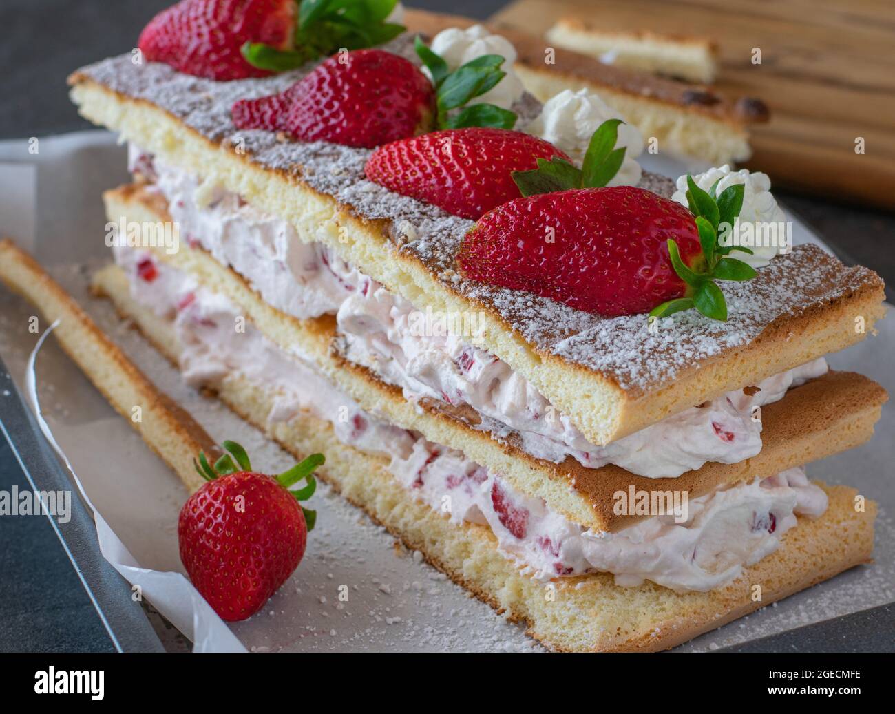 Homemade strawberry cream cake on rustic table background Stock Photo ...