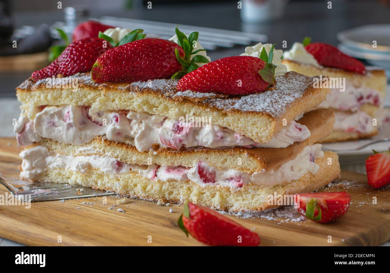 Homemade strawberry cream cake on rustic table background Stock Photo ...
