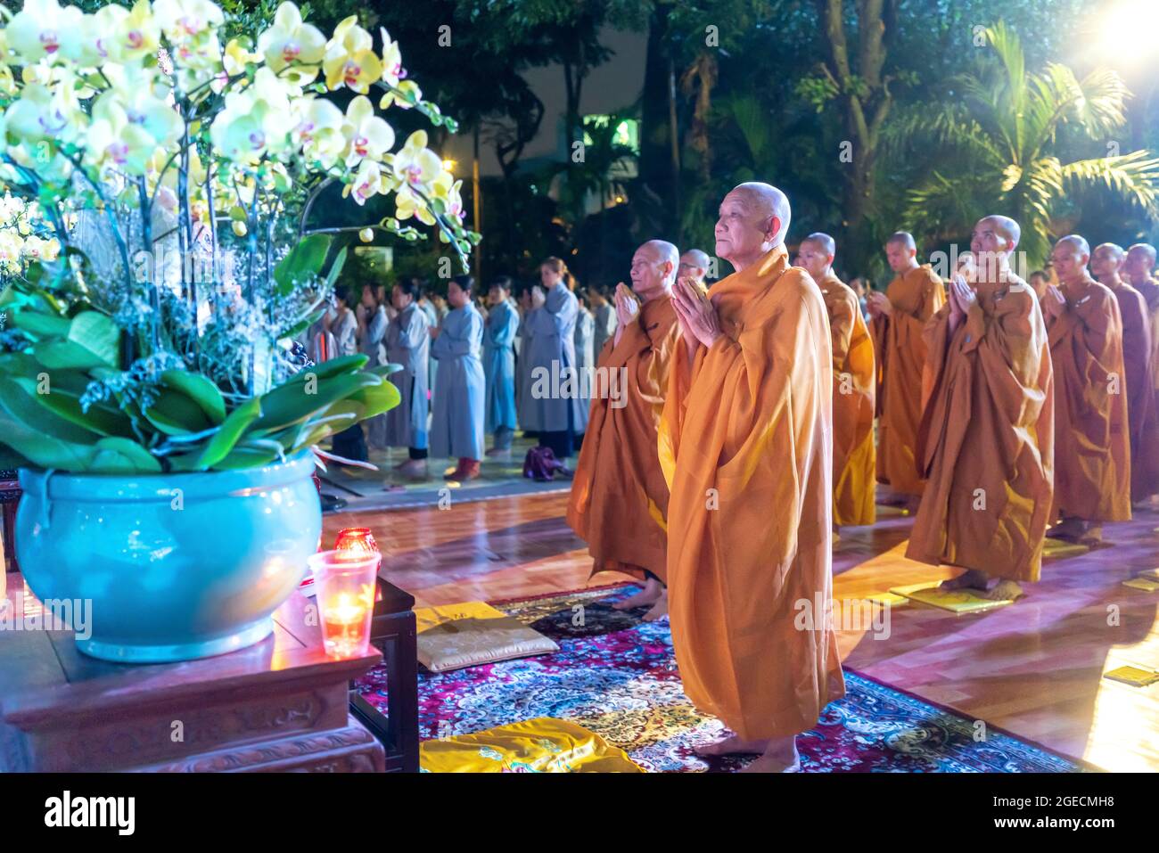 Kneeling monks in temple praying hi-res stock photography and images ...