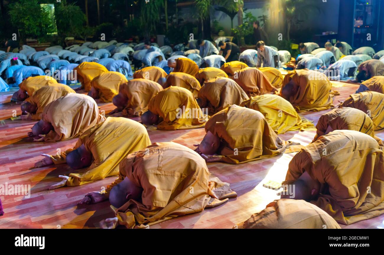 Monks are reverently bowing to Buddha during evening ceremony for ...