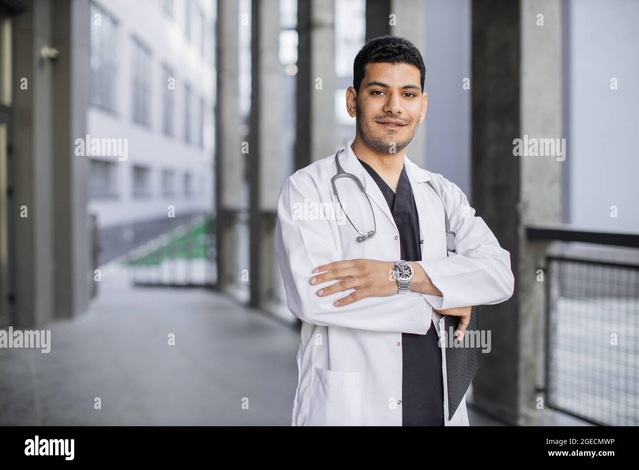 Horizontal waist-up portrait of a handsome male Arab Malay doctor ...
