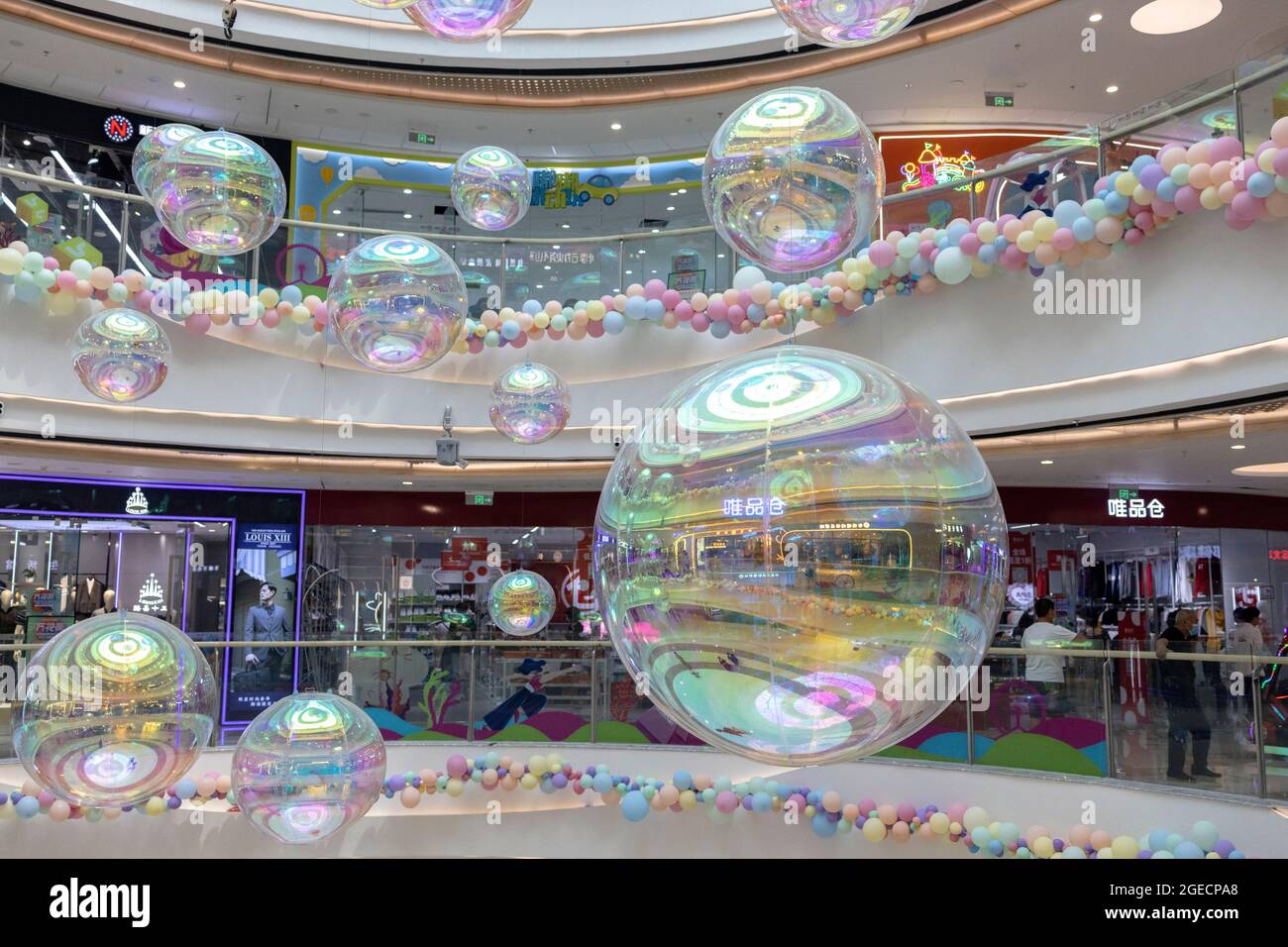Huge balloons hang in the mid-air of the center of a Wanda shopping ...