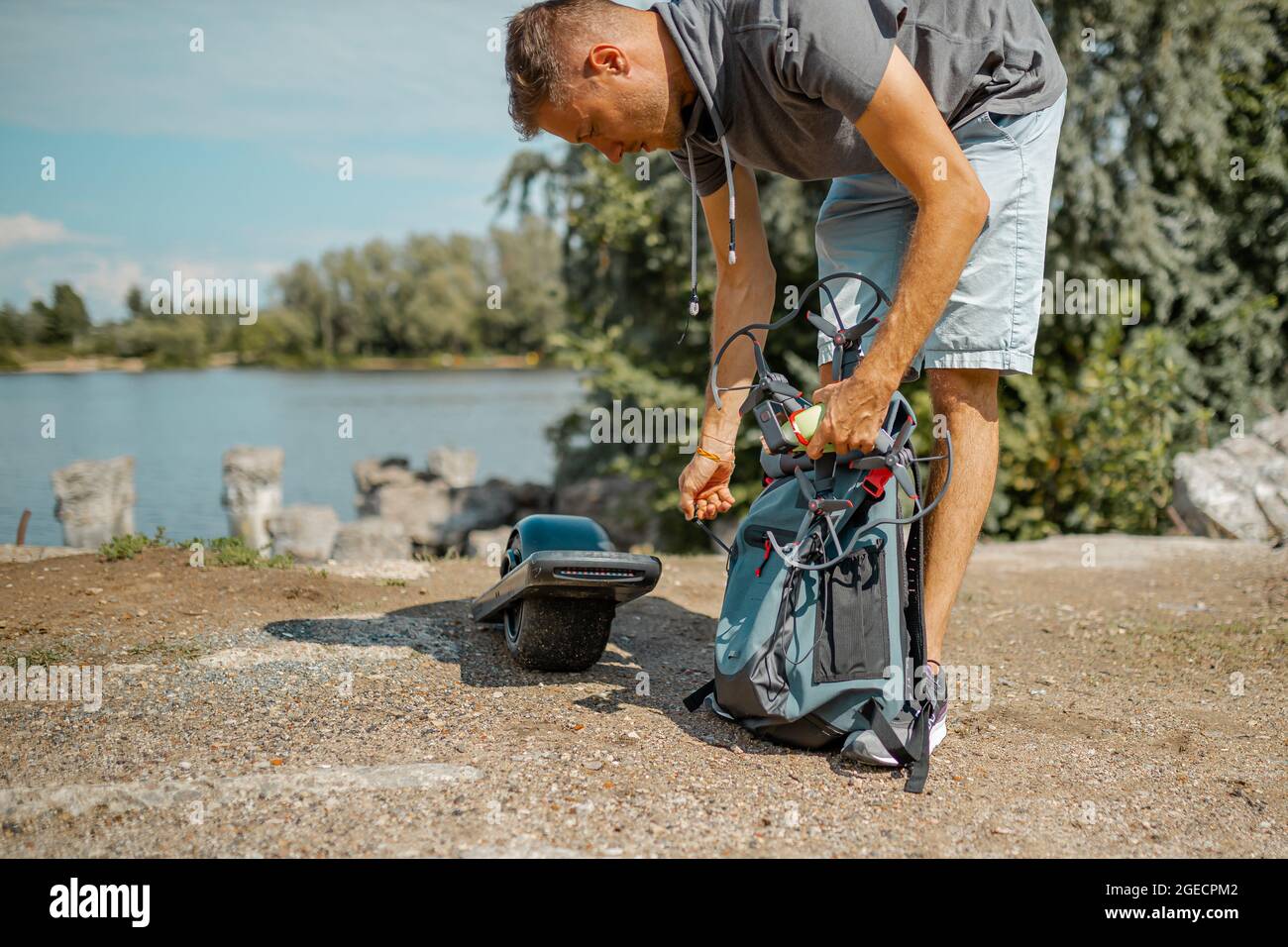 Young man packing his travel backpack with a camera gear Stock Photo ...