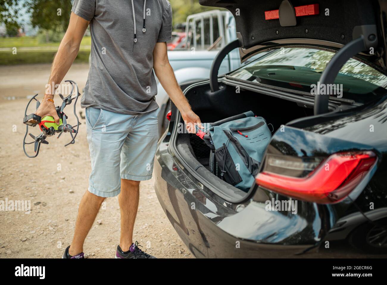 Handsome man getting ready for a vacations, loading his backpack in a ...