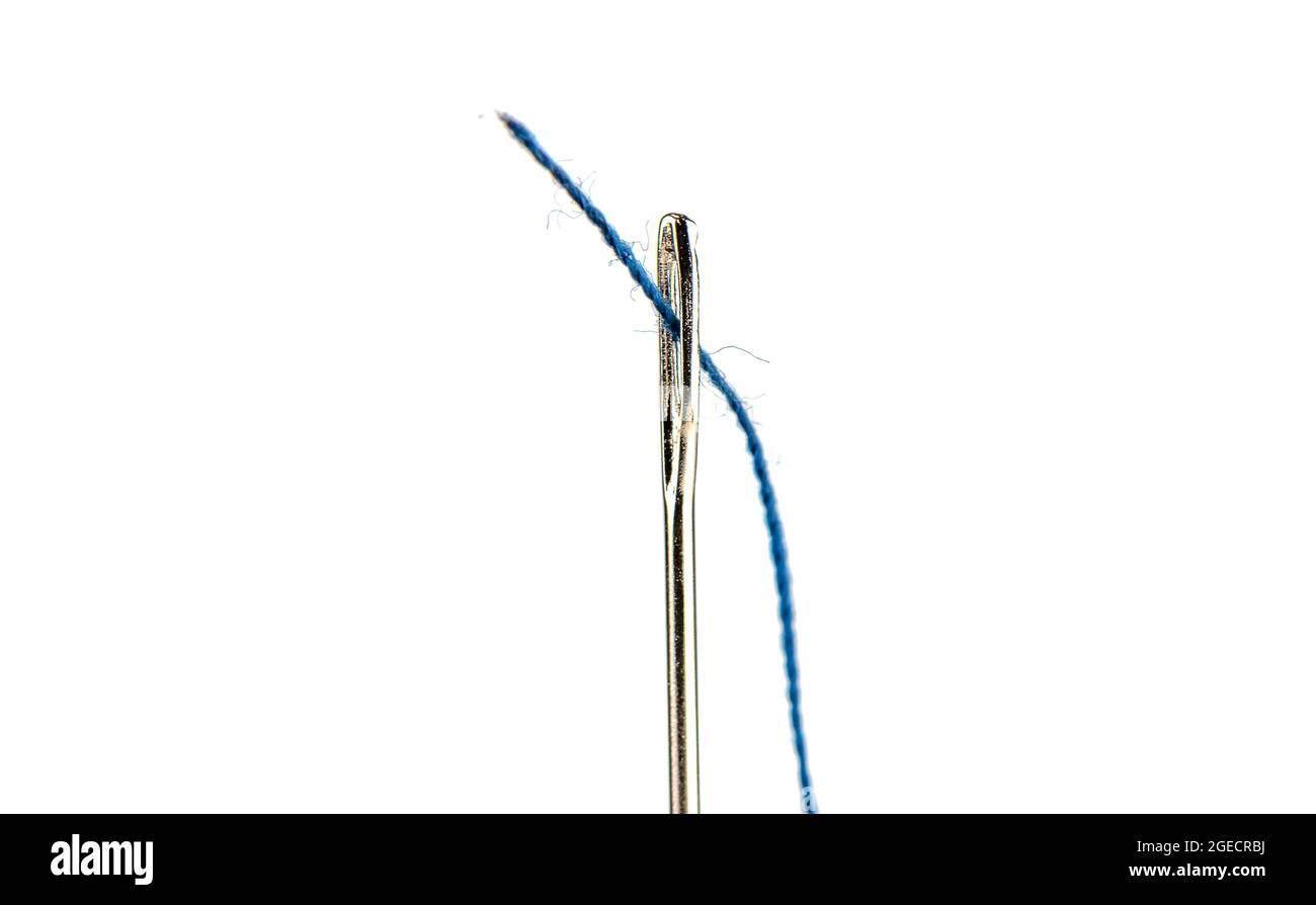 Needle and blue thread isolated on white background. Close up. Copy ...