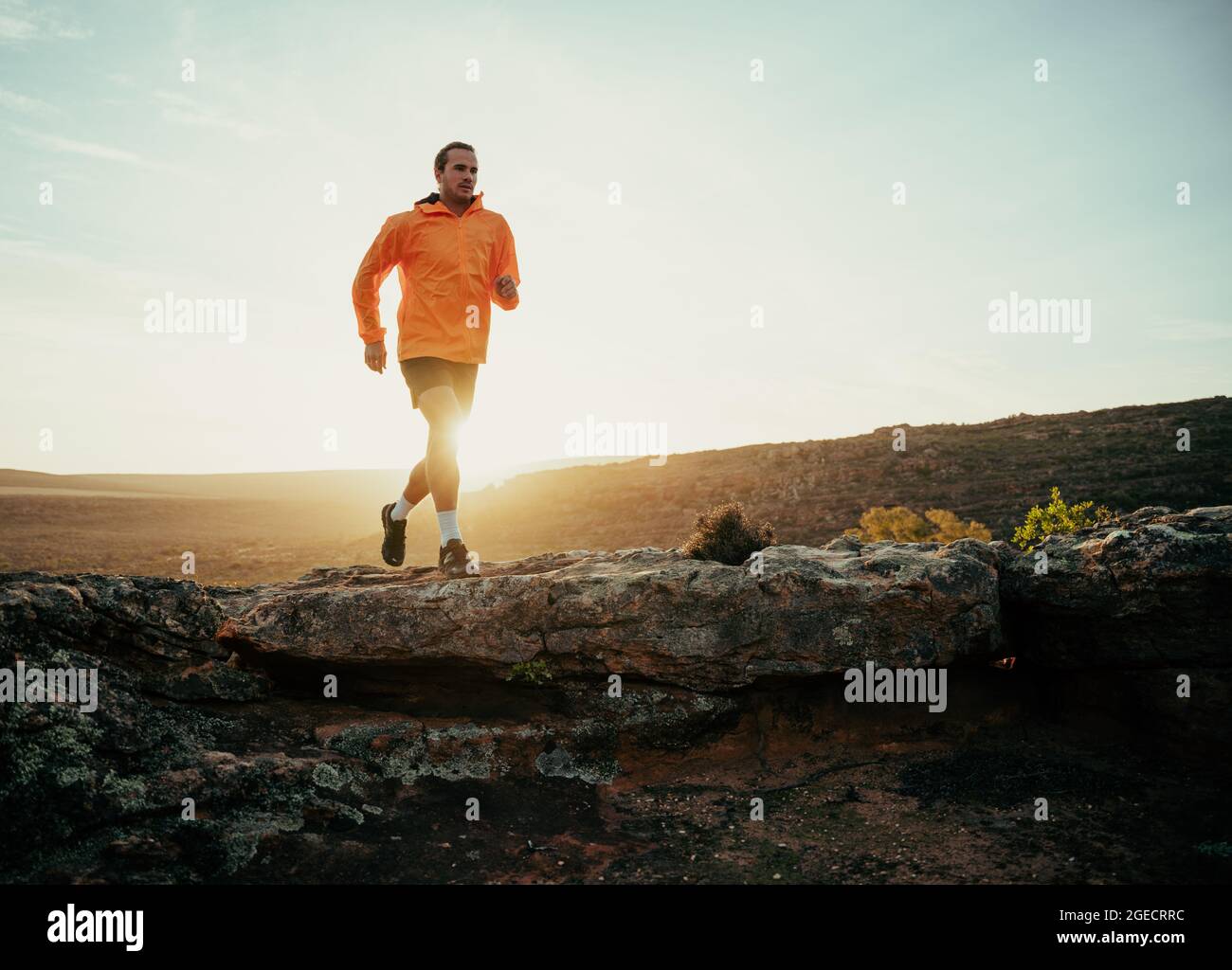 Smiling explorer looking mountain during sunset hi-res stock ...