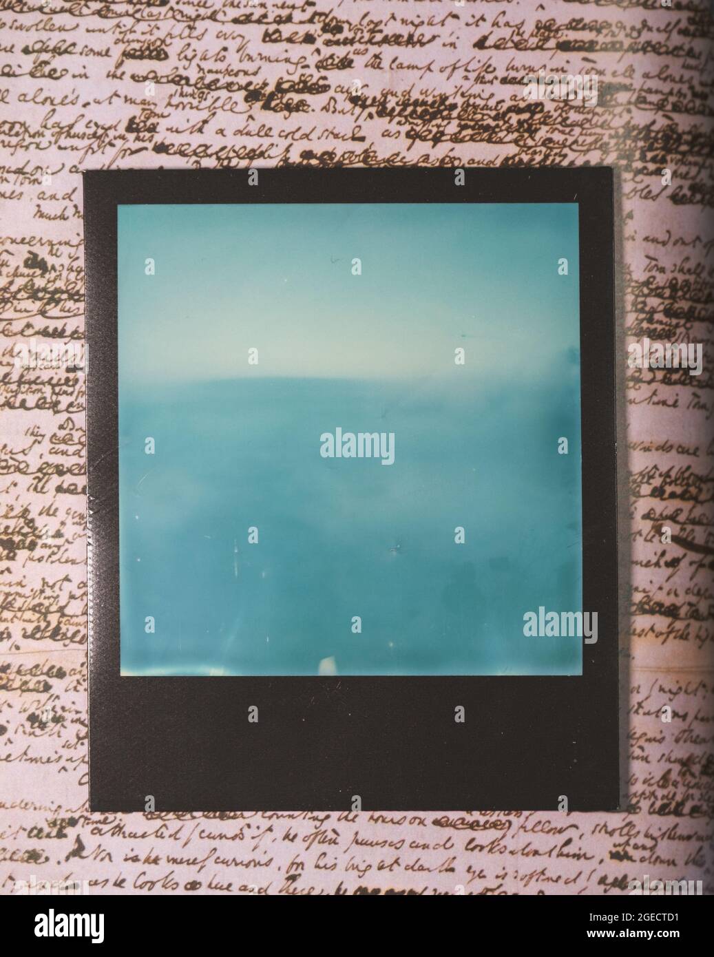 Blue monochrome photo frame on old handwritten paper background as ...