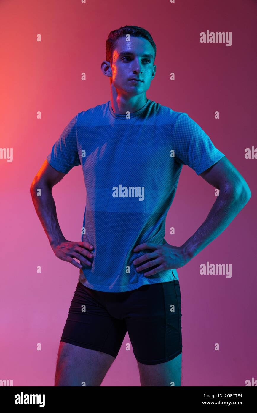 Portrat of Caucasian young sportive man in sportswear standing isolated ...