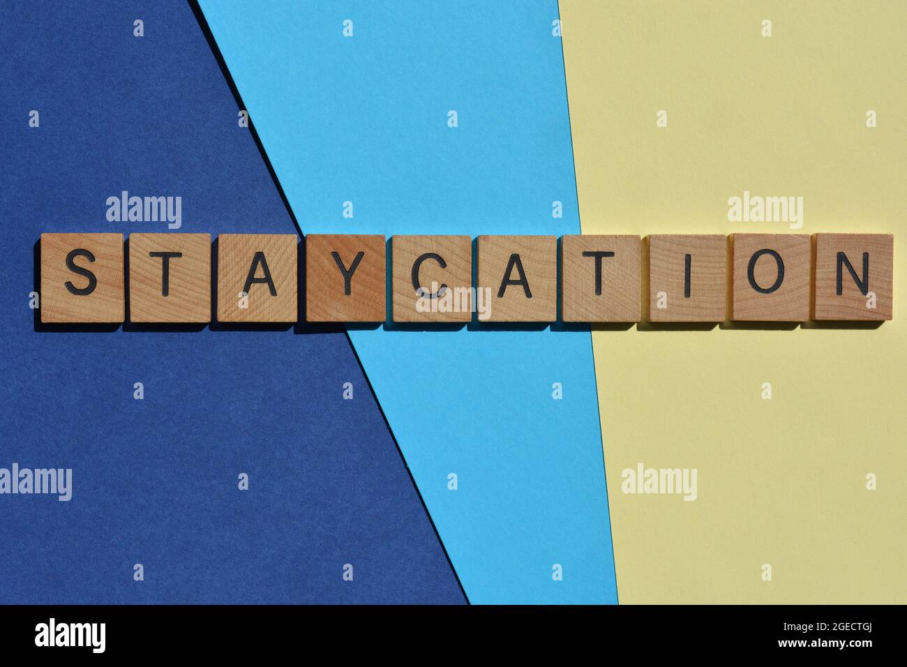 Staycation, word in wooden alphabet letters isolated on background ...