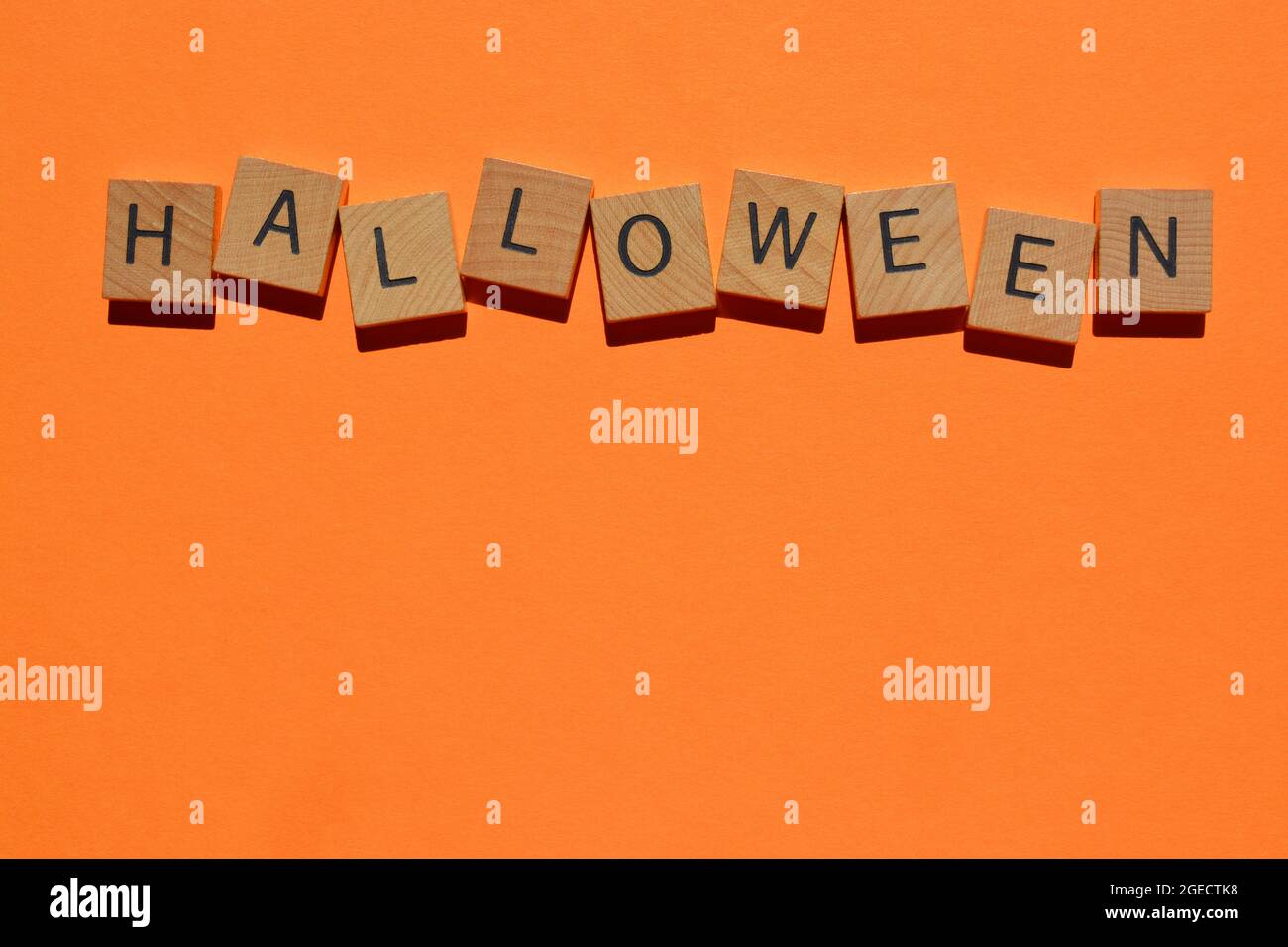 Halloween, word in wooden alphabet letters isolated on orange ...