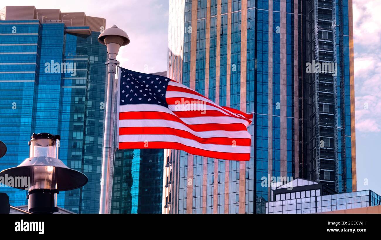 Flying American flags surrounded by high rise skyscrapers in New York ...