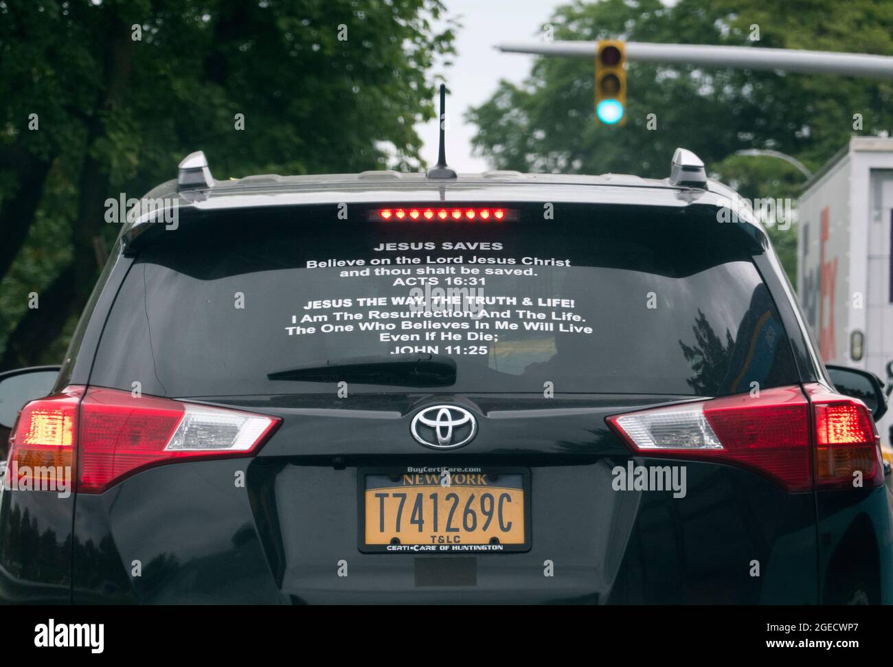 A livery cab's rear qindow with quotes from the new Testaent books of ...