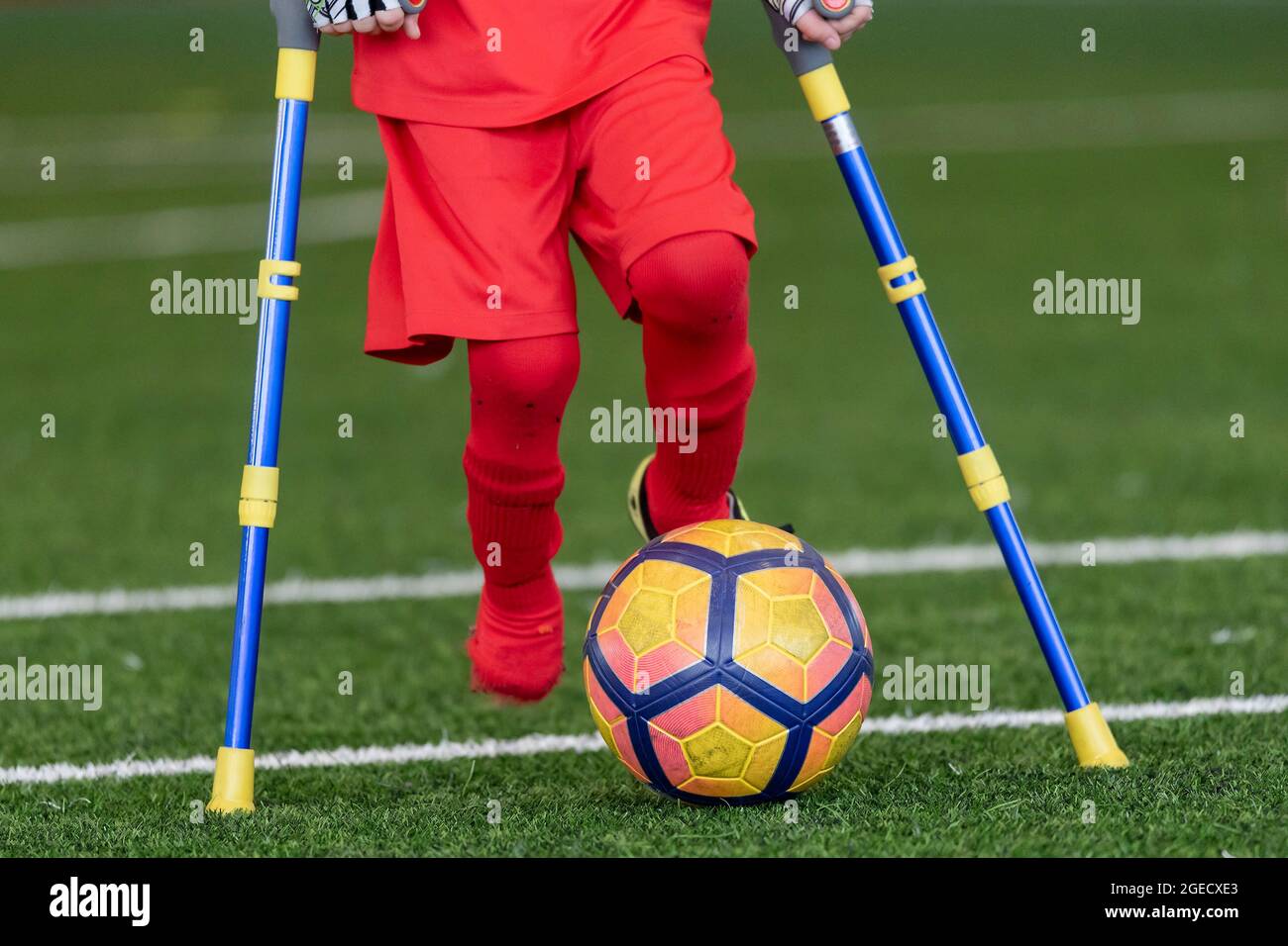 Legs of disabled football plaer with ball and crutches Stock Photo - Alamy
