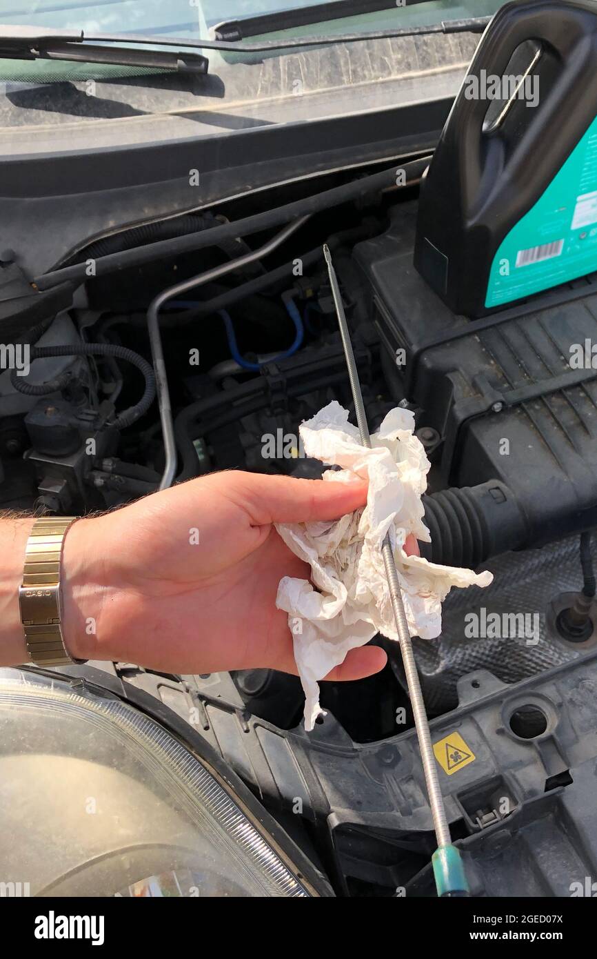 a man checking the engine oil level of his car Stock Photo - Alamy