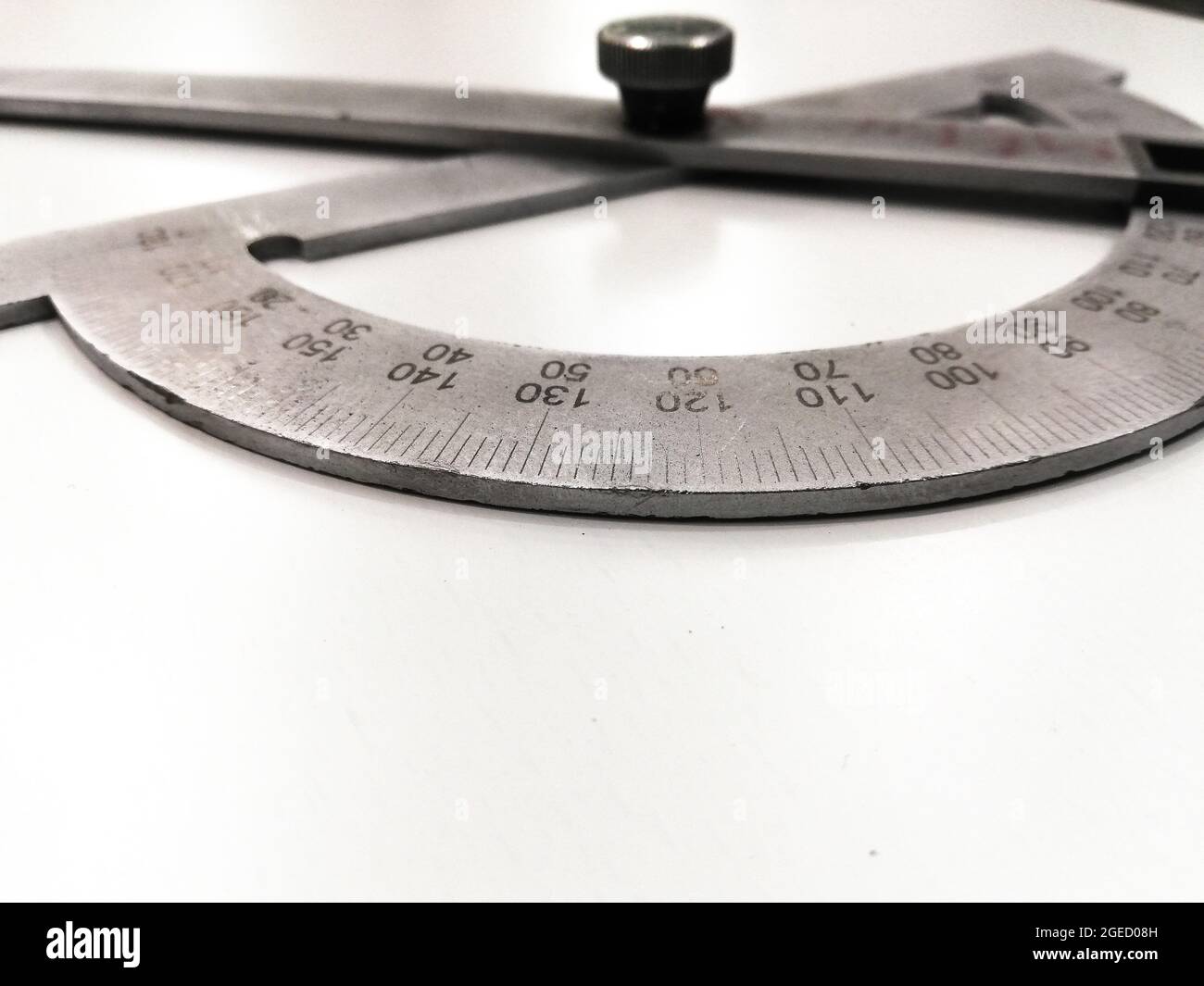 Detail shot of a metal protractor on a white background Stock Photo - Alamy