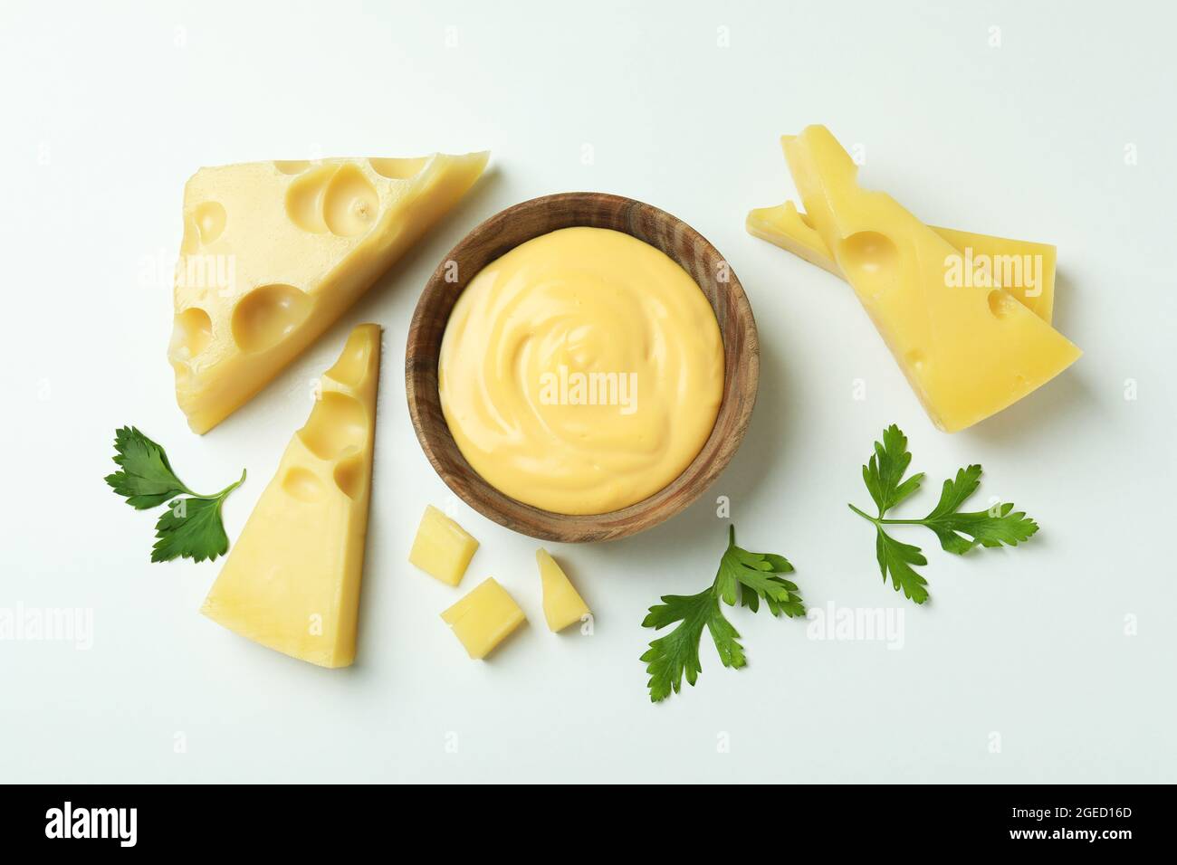 Bowl of cheese sauce and ingredients on white background Stock Photo ...