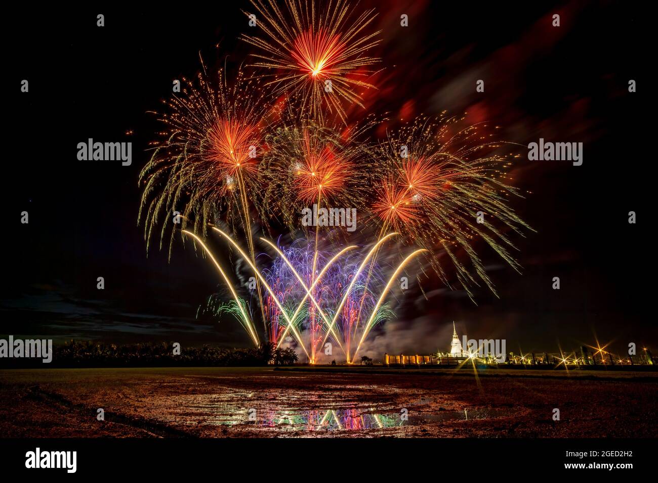 Huge, colorful fireworks over the rice fields at dusk Stock Photo - Alamy