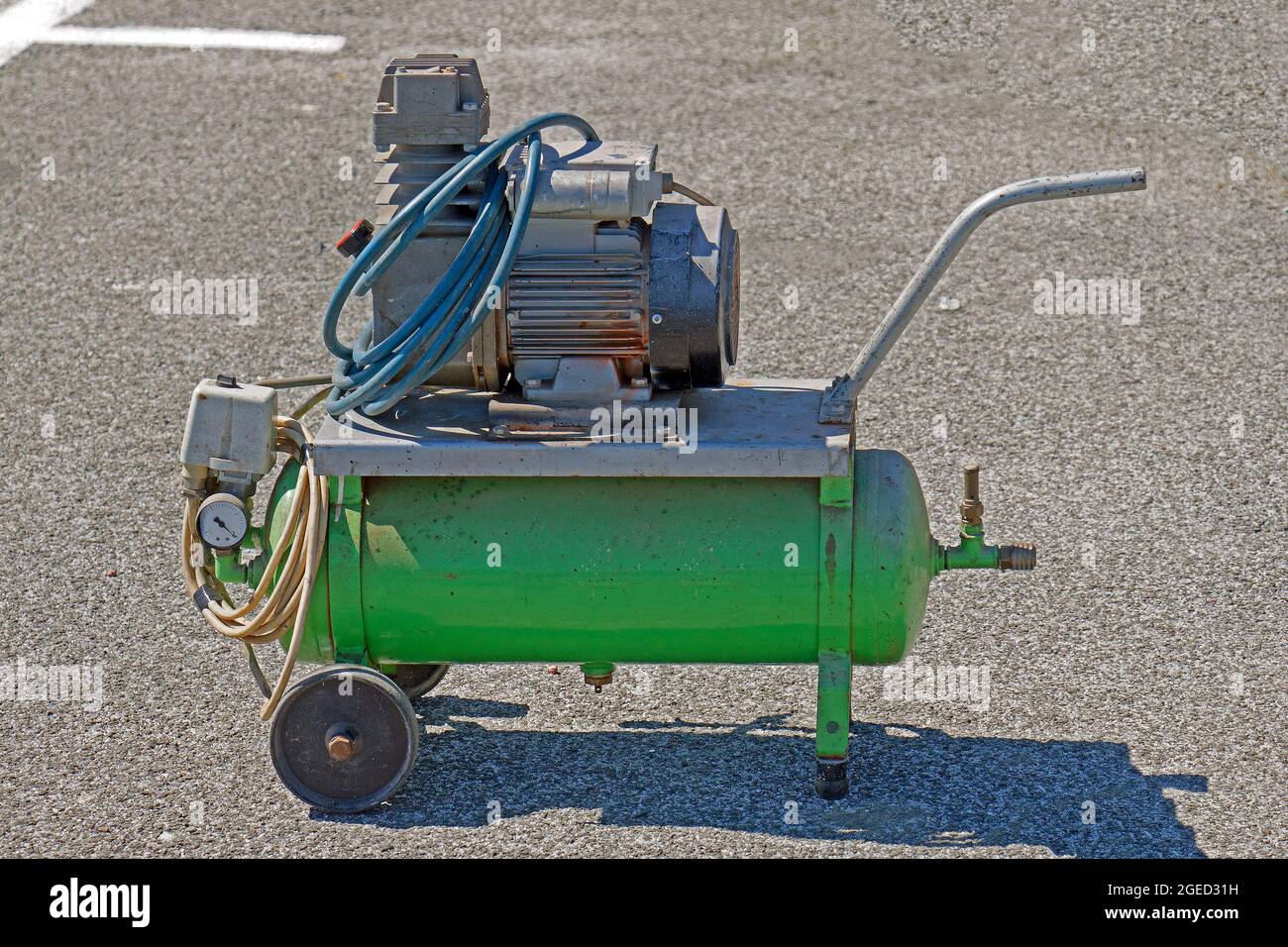 Air compressor in metal container outdoors on pavement Stock Photo - Alamy
