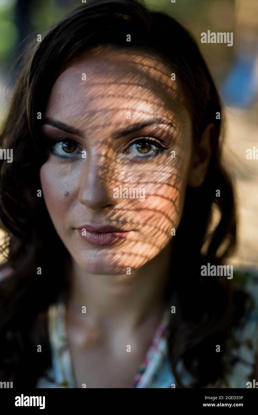 Portrait of a pretty European female with a shadow on her face Stock ...