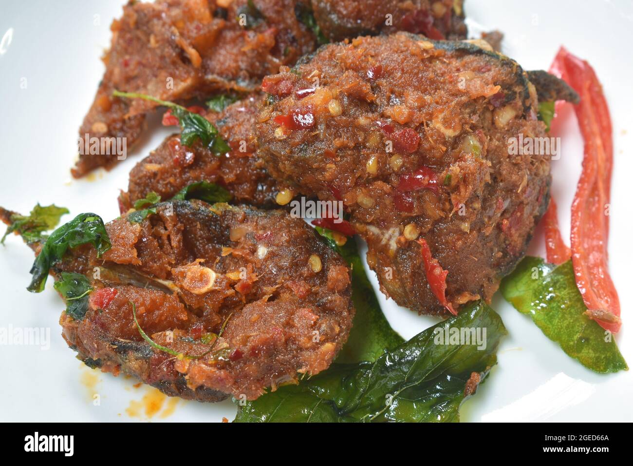 spicy stir fried crispy catfish curry with basil leaf on plate Stock ...