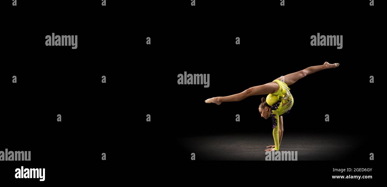 Slim sportive girl, rhythmic gymnastics artist in bright stage costume ...