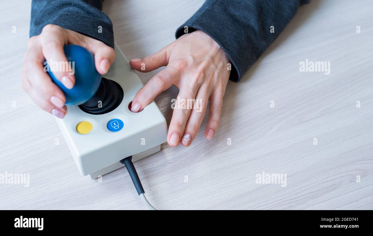 Woman with cerebral palsy works on a specialized computer mouse Stock ...