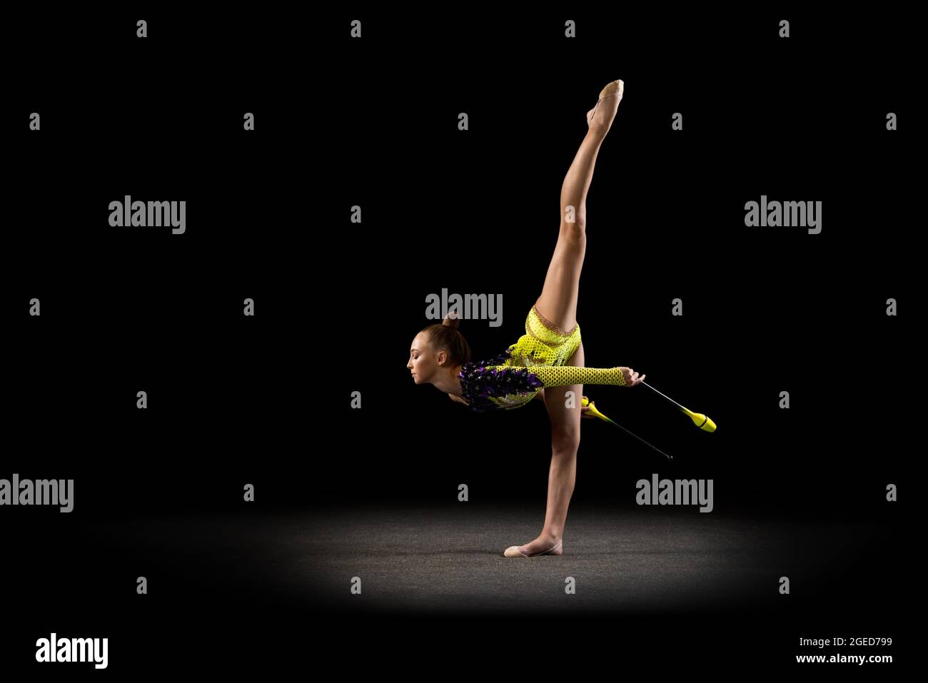 Slim sportive girl, rhythmic gymnastics artist in bright stage costume ...