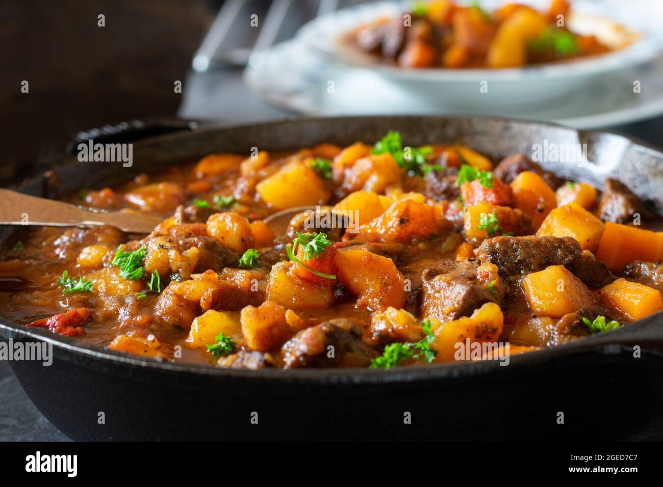 Irish beef stew in a cast iron pan. Closeup and front view with blurred ...