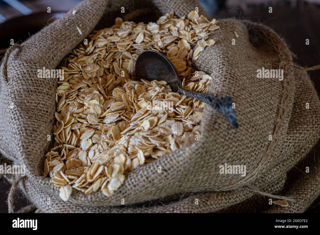 Rolled oats or oat flakes in jute bag Stock Photo - Alamy