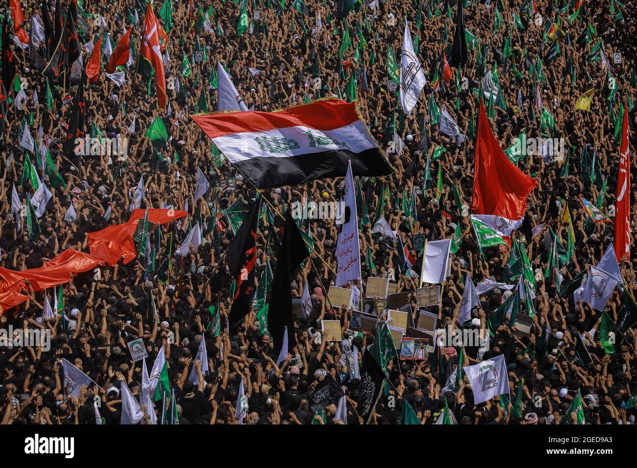 Karbala, Iraq. 19th Aug, 2021. People crowd as they take part in the ...