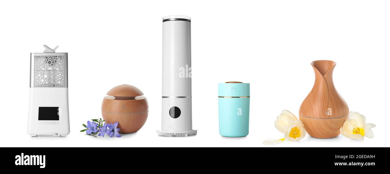Different modern humidifiers on white background Stock Photo - Alamy