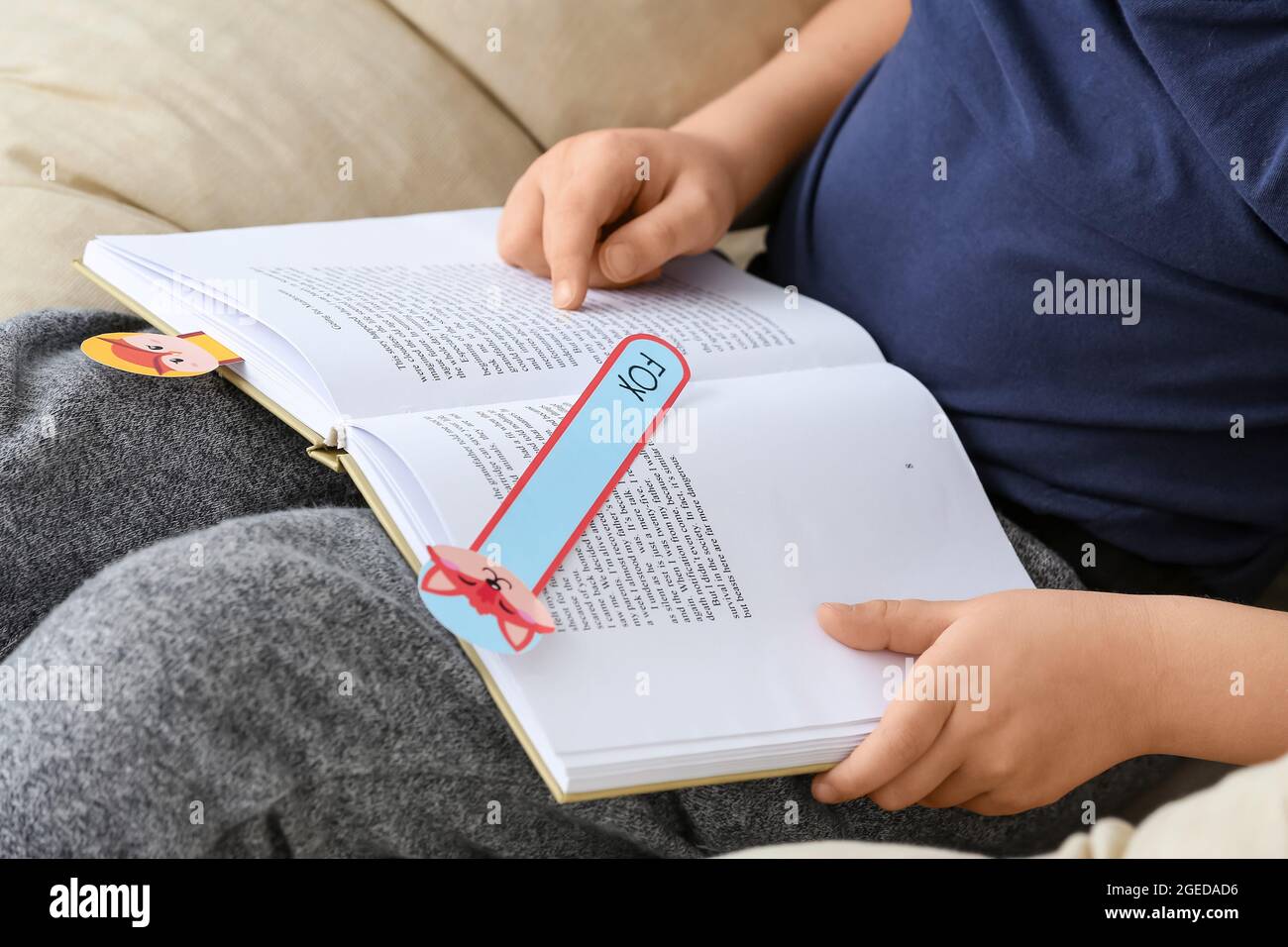 Little child with cute bookmarks reading book at home Stock Photo - Alamy