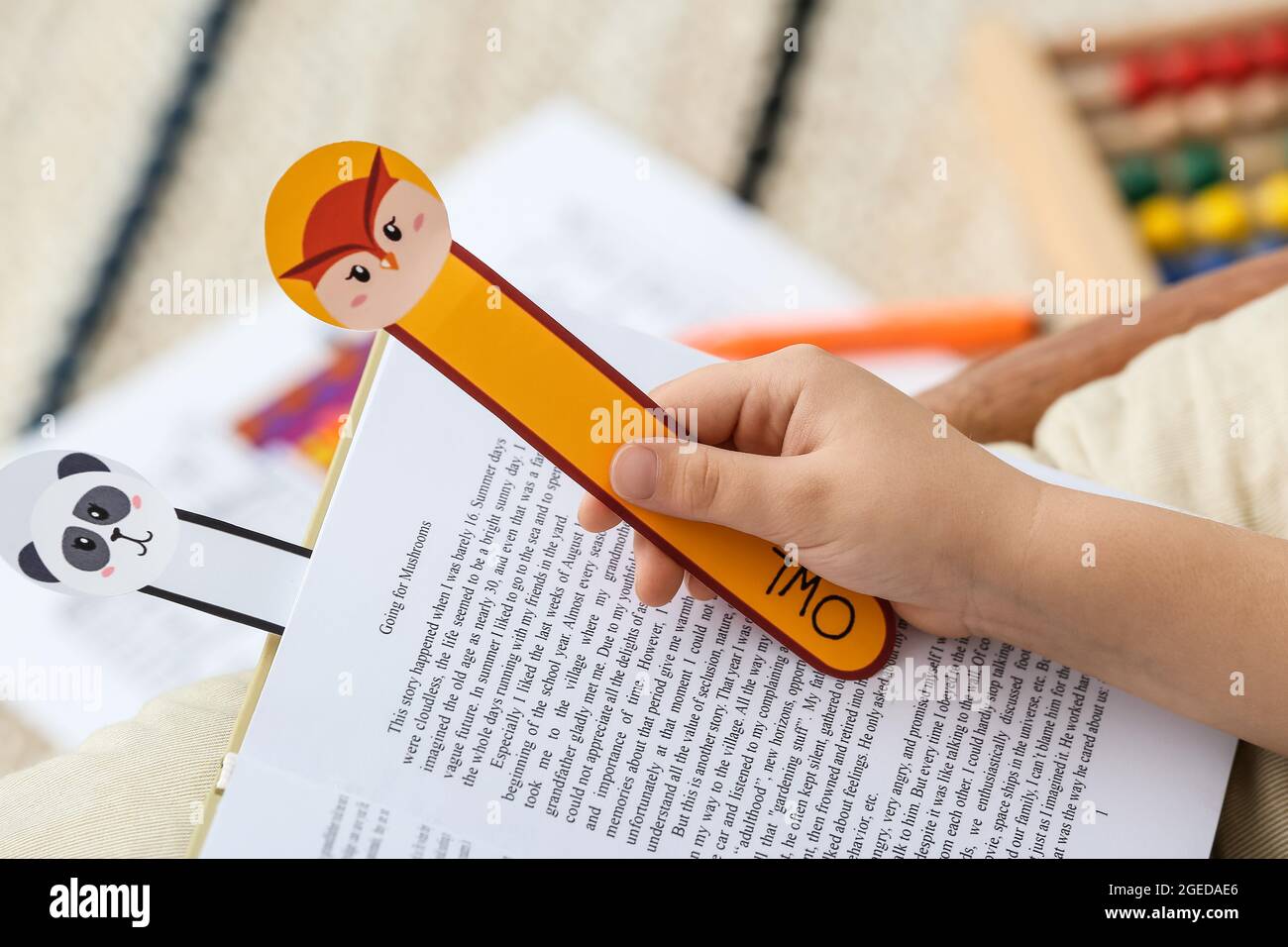 Little child with cute bookmarks reading book at home Stock Photo - Alamy