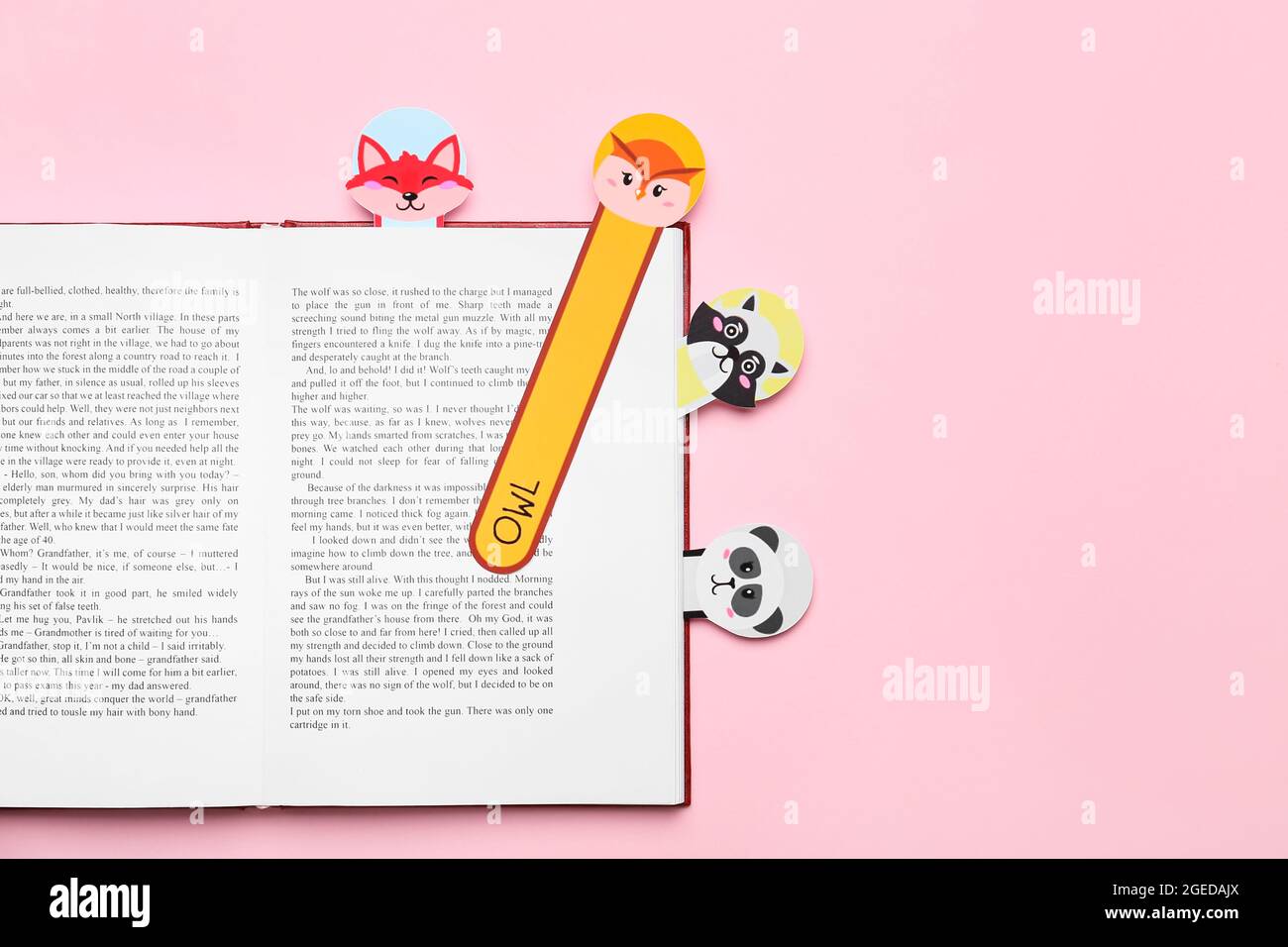 Cute bookmarks with book on color background Stock Photo - Alamy