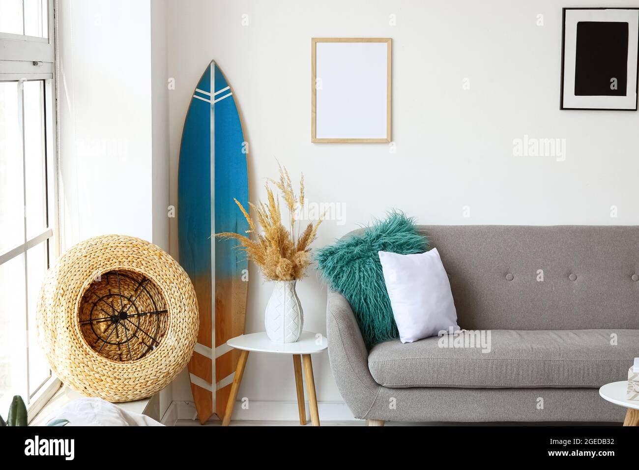 Interior of modern stylish room with surfboard and sofa Stock Photo - Alamy