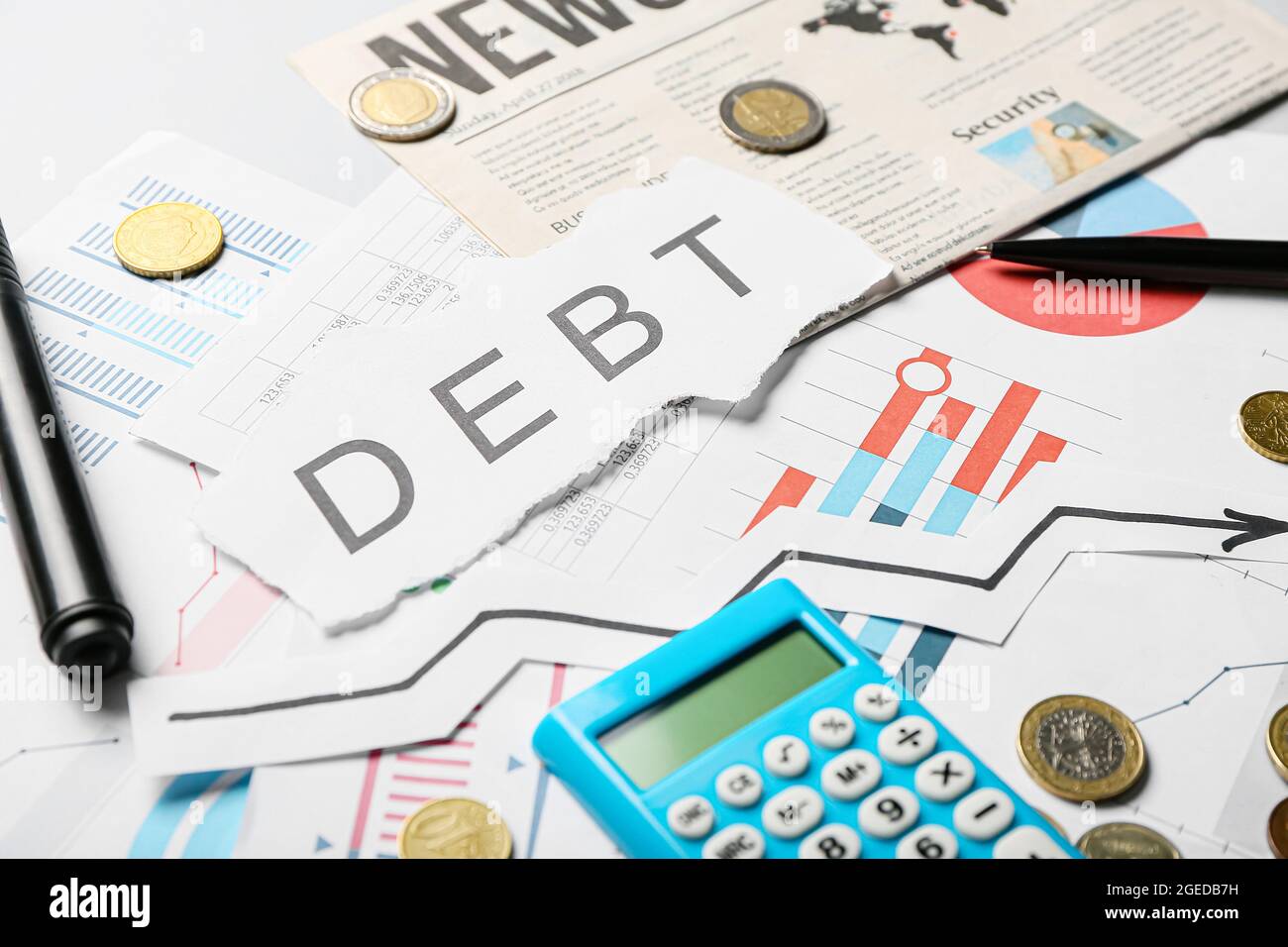Word DEBT with charts, coins and stationery on light background Stock ...