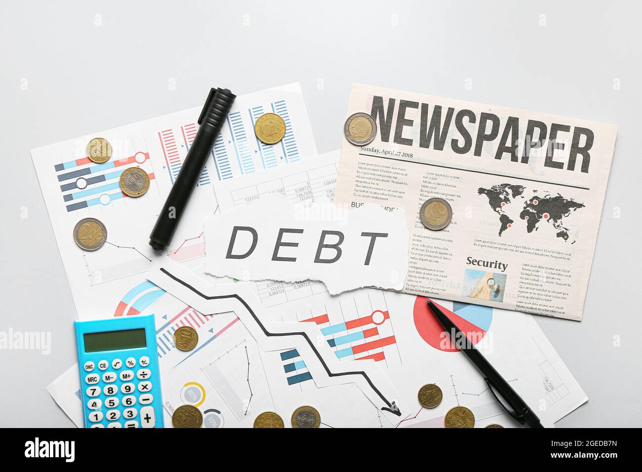 Word DEBT with charts, coins and stationery on light background Stock ...