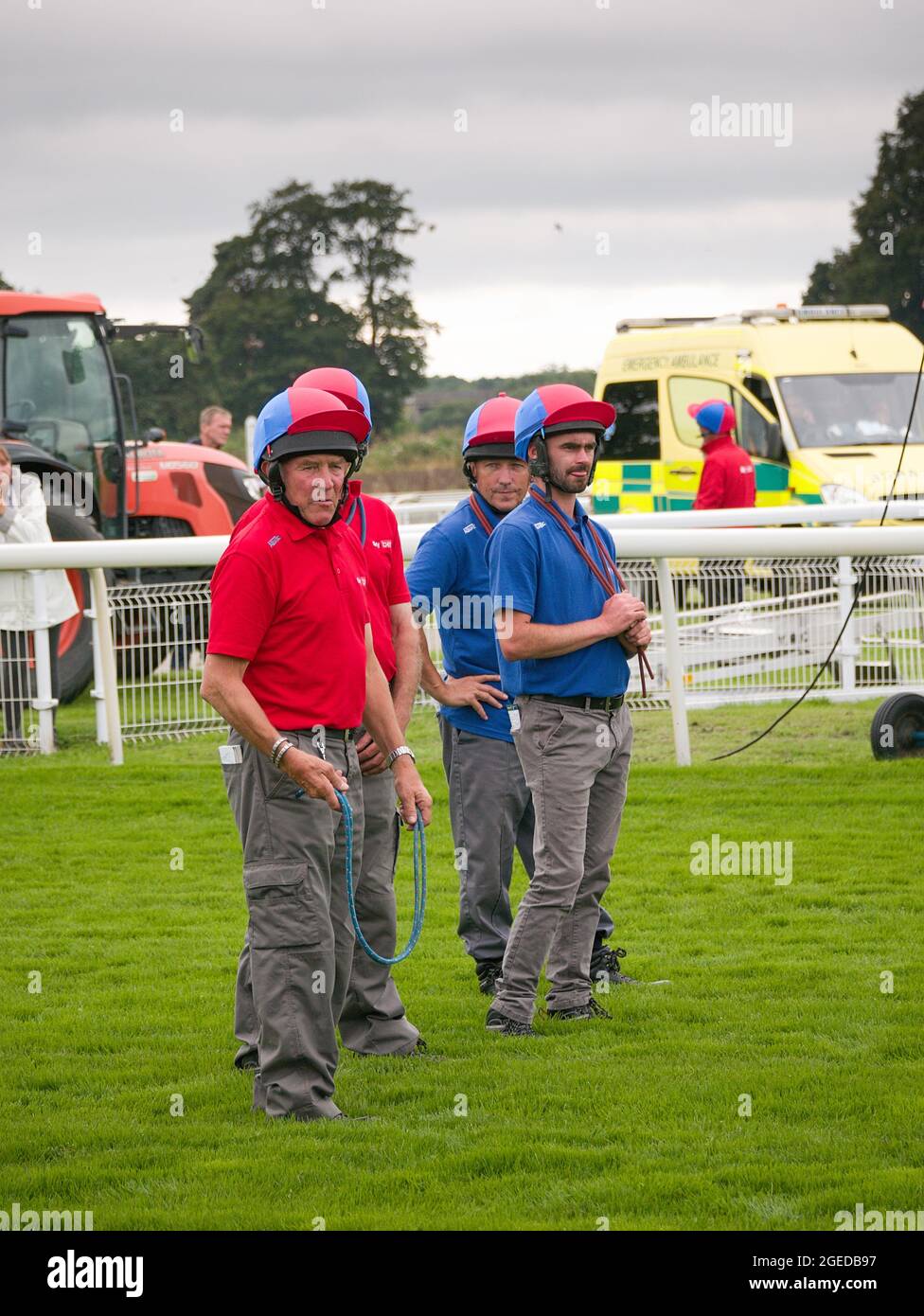 Racecourse staff waiting for jockeys and their horses to arrive before ...