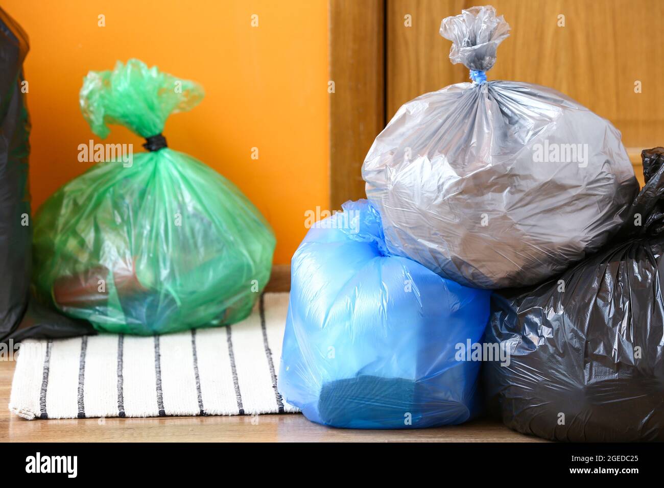 Bags with garbage near door Stock Photo - Alamy
