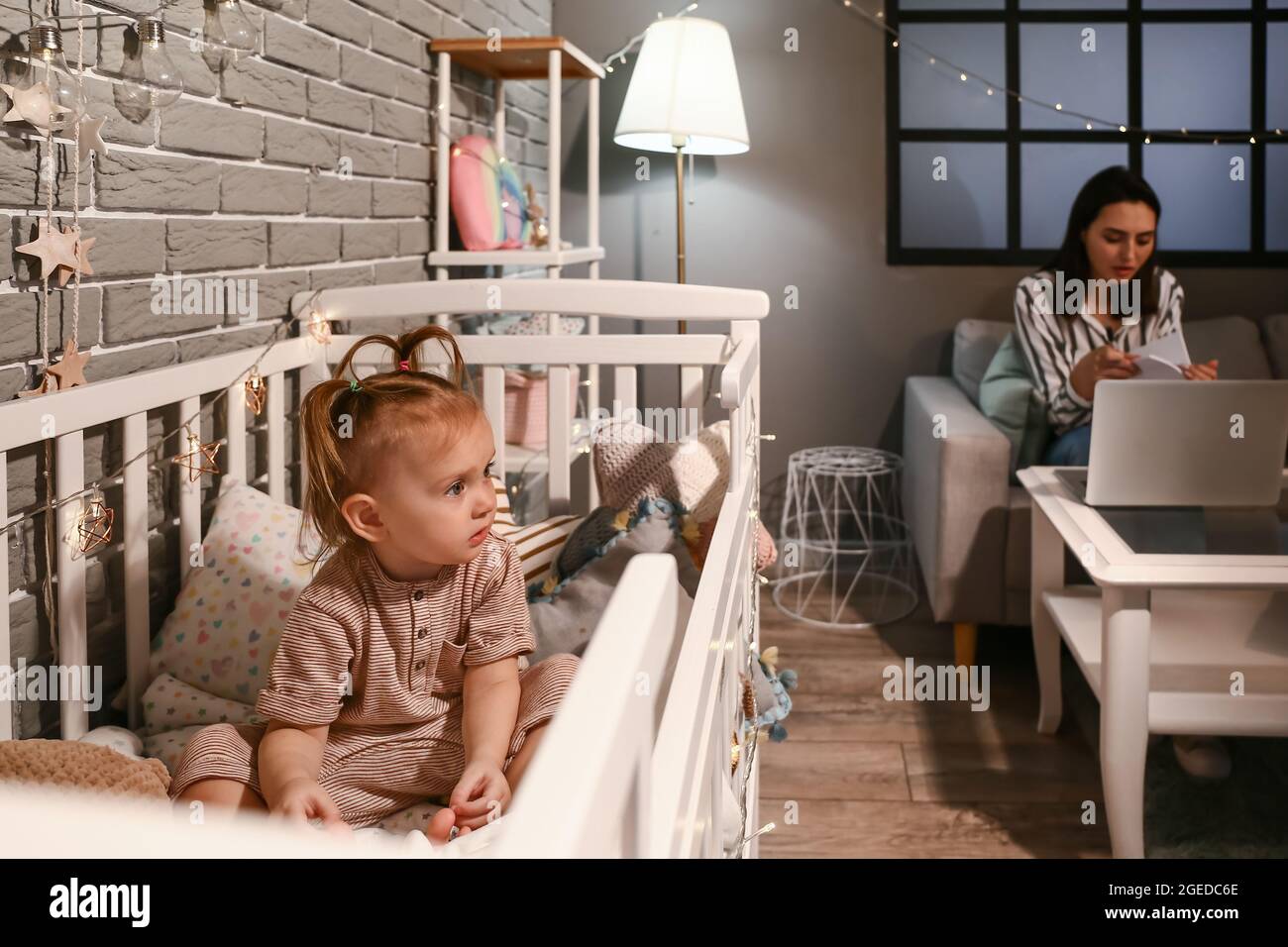 Cute little baby in crib at home Stock Photo - Alamy