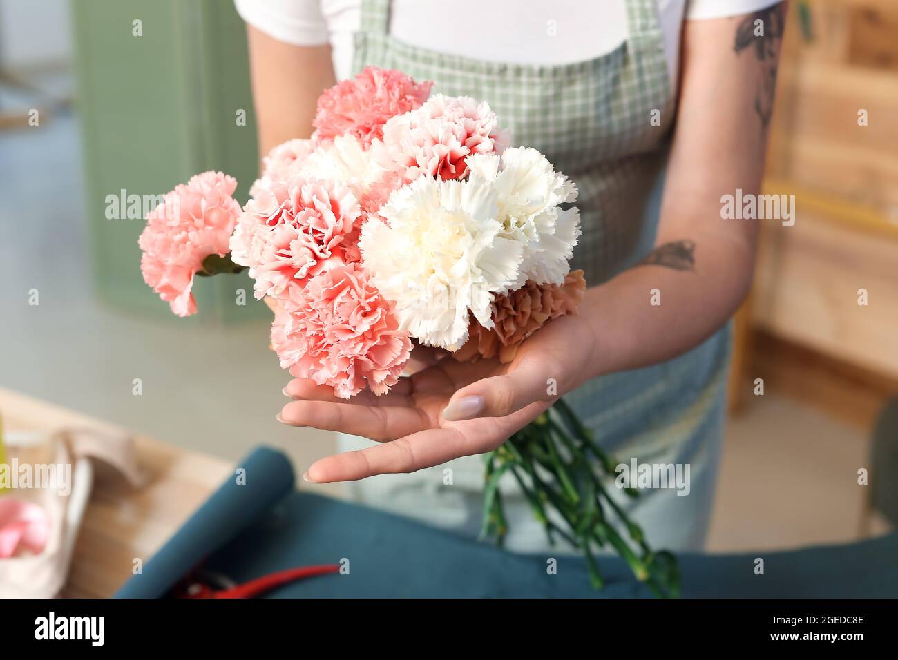 Female florist with carnation flowers in workshop, closeup Stock Photo ...