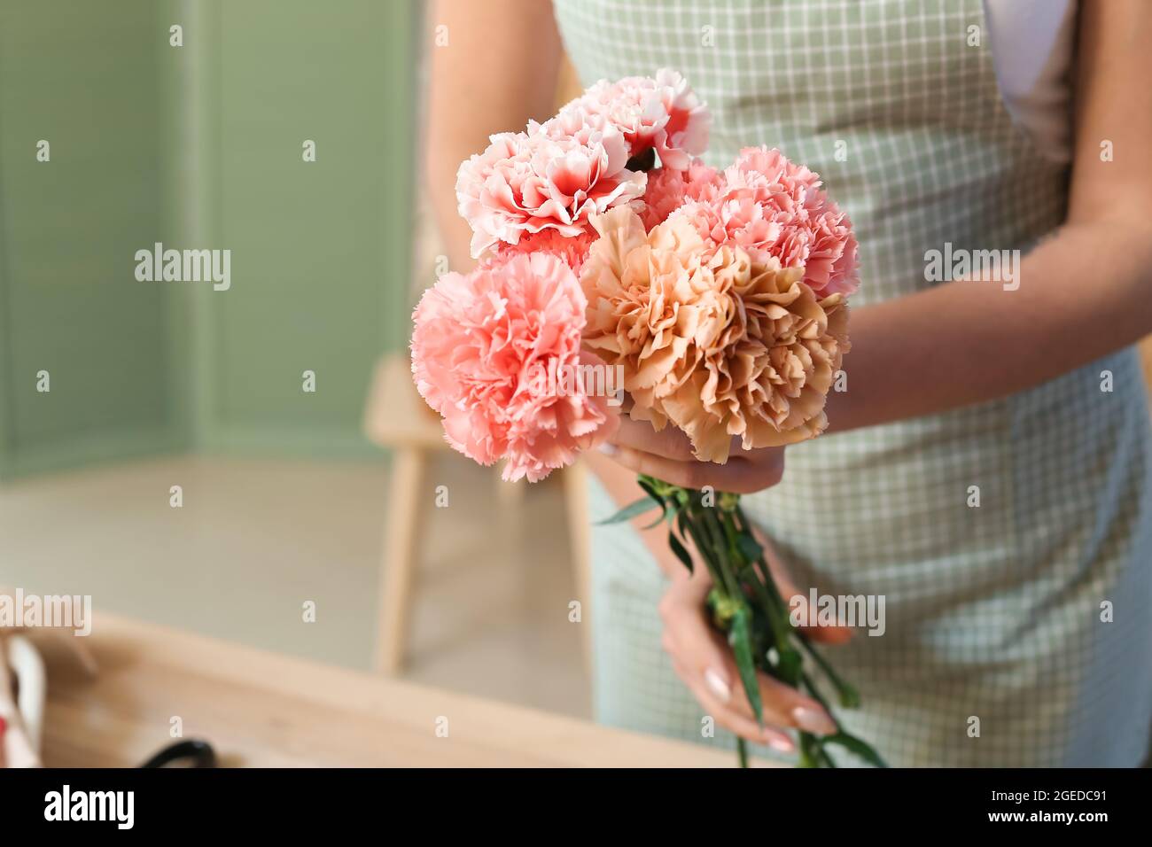 Female florist with carnation flowers in workshop, closeup Stock Photo ...