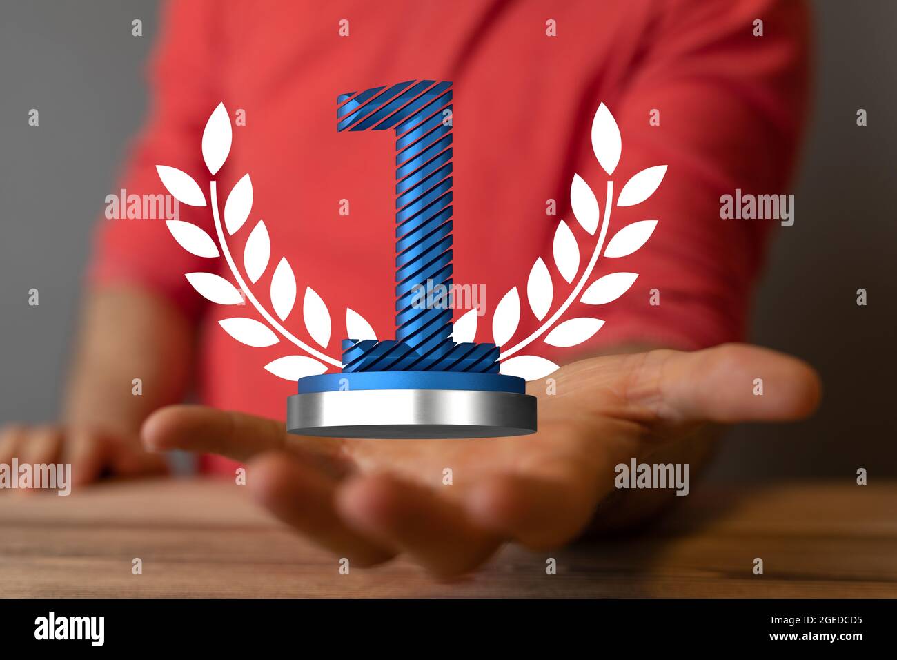 Businessman holding a digital illustration of a trophy of a winner ...