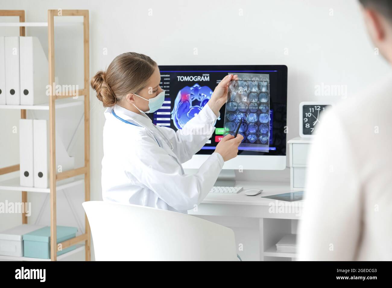 Female doctor showing x-ray scan to patient in clinic Stock Photo - Alamy
