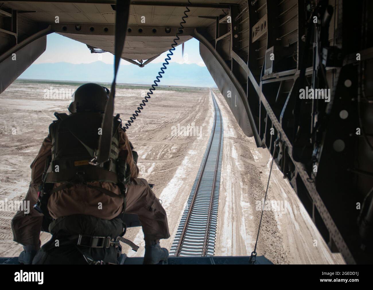 The rear-gunner in a Sikorsky UH-53 helicopter watches the end of the ...