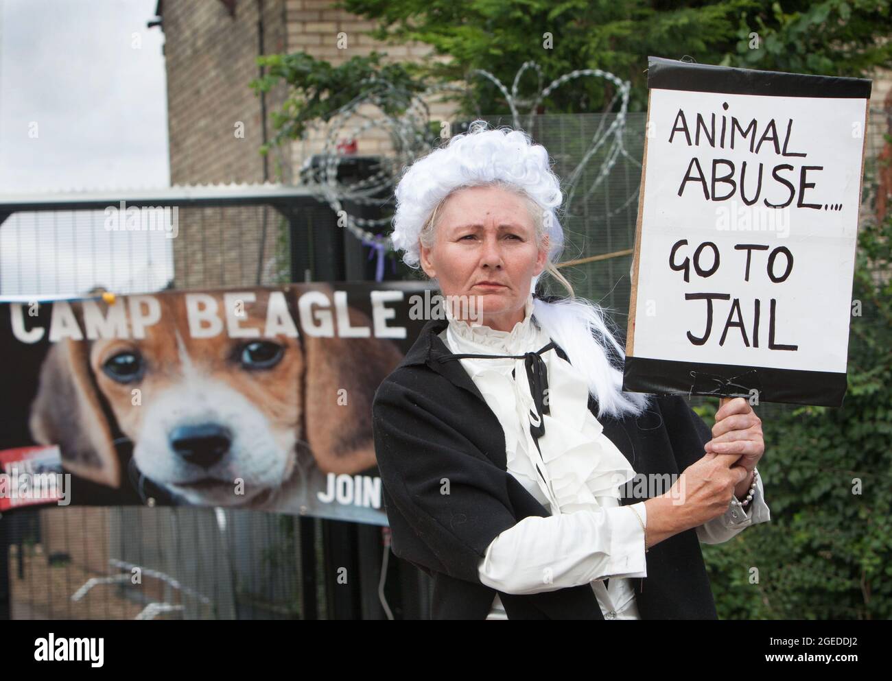 A protester dressed as a judge holds up a sign reading "Animal Abuse ...