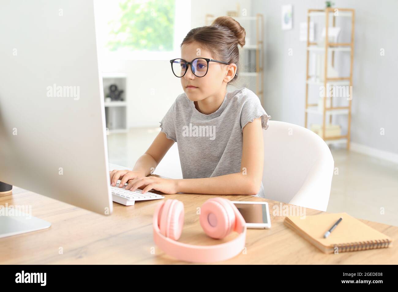 Cute little programmer using computer in office Stock Photo - Alamy