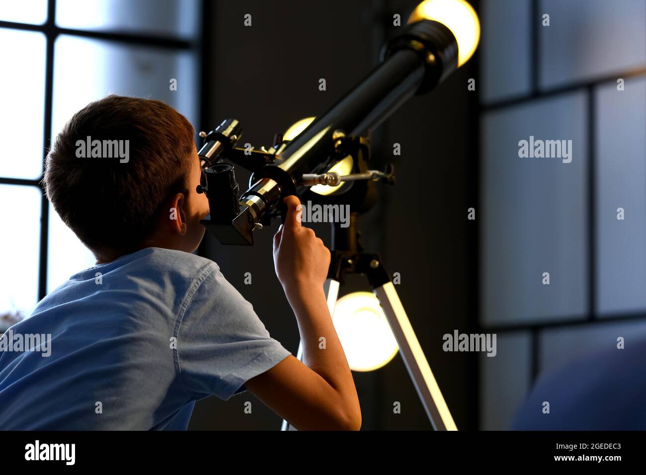 Little boy with telescope looking at stars in evening Stock Photo - Alamy